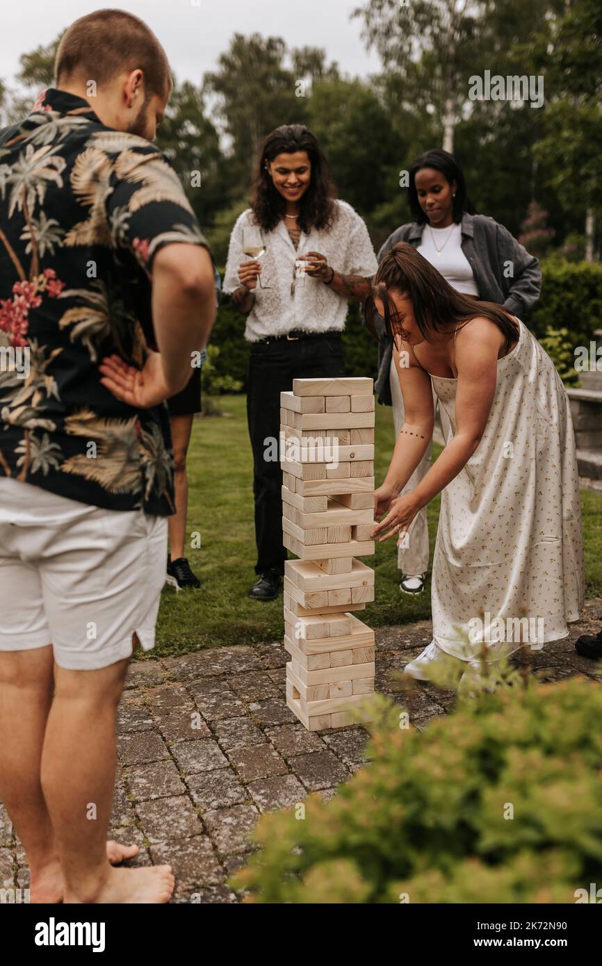 Friends playing jenga in garden Stock Photo - Alamy