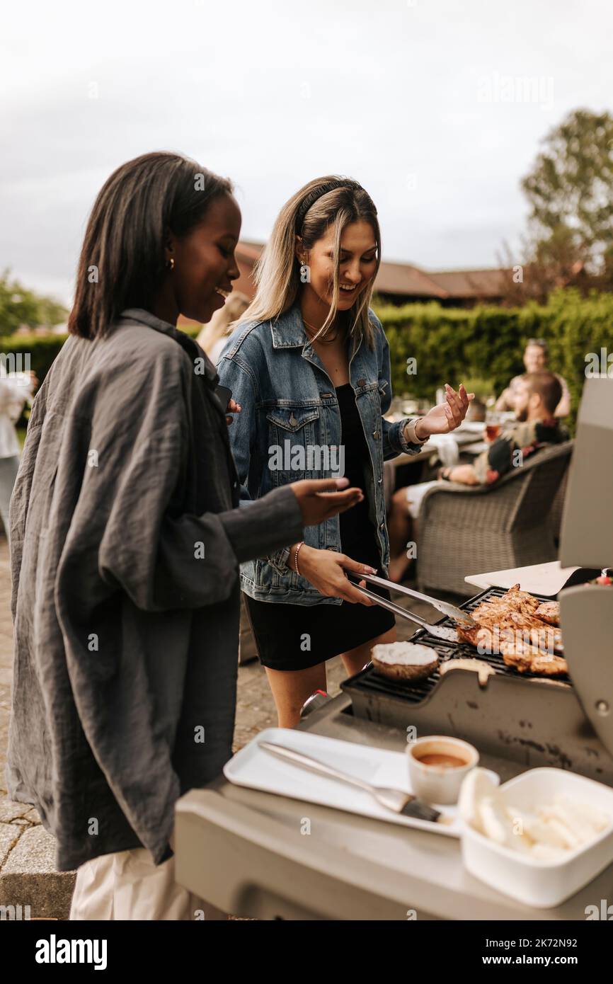 Women having barbecue in garden Stock Photo - Alamy