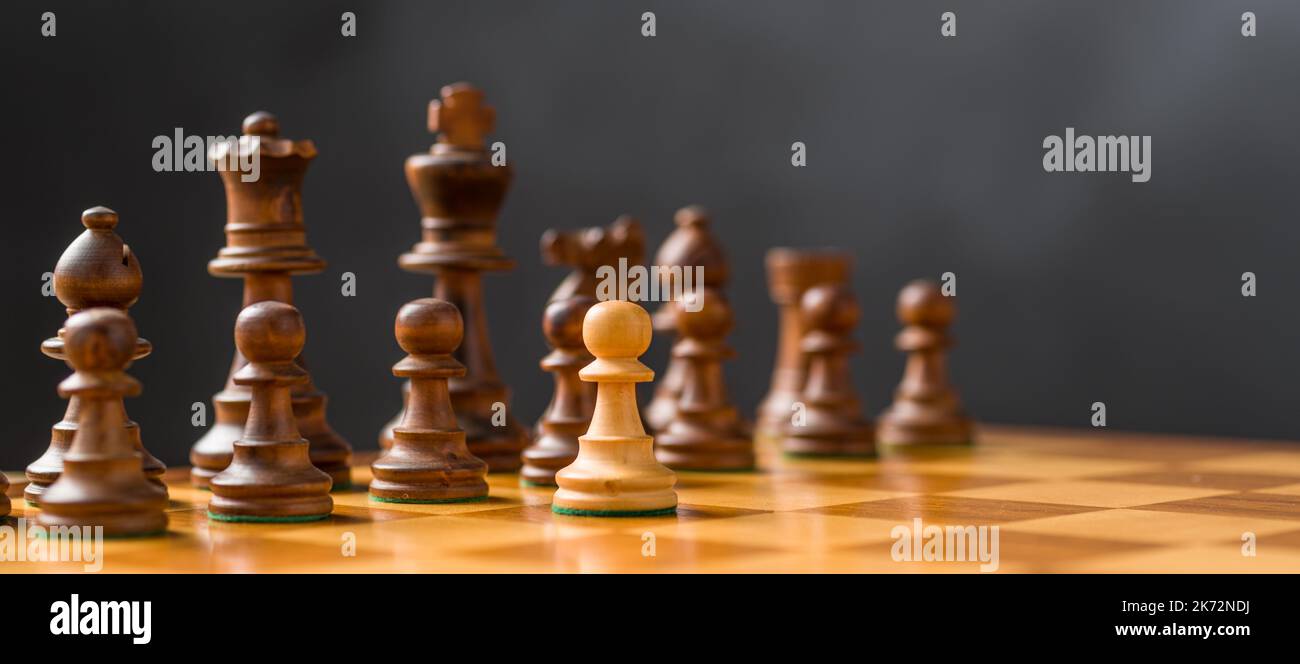 Concept with chess pieces - One against all Stock Photo - Alamy