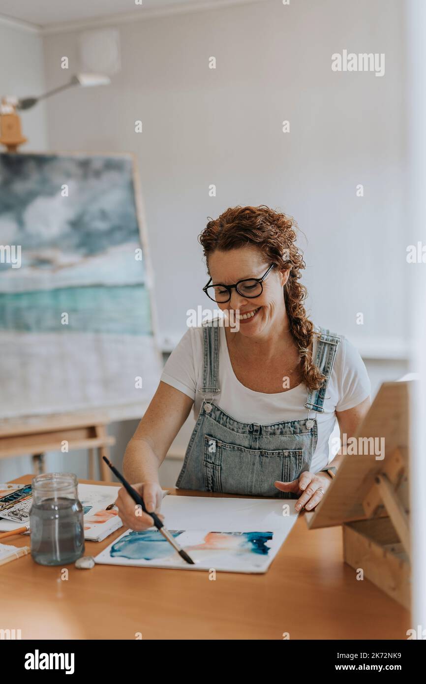 Artist painting in studio Stock Photo - Alamy