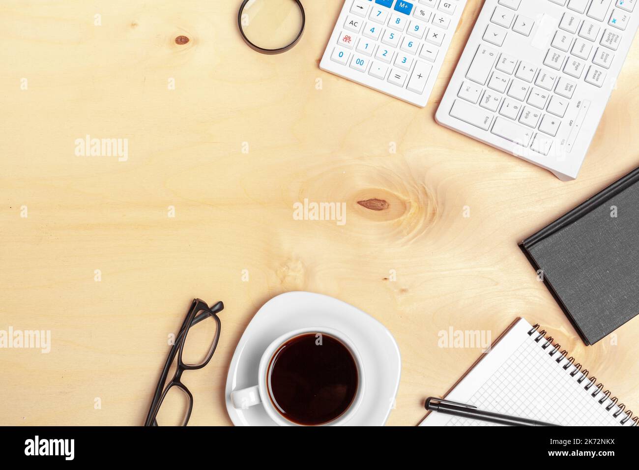 Office table with note paper, computer keyboard and supplies close up ...