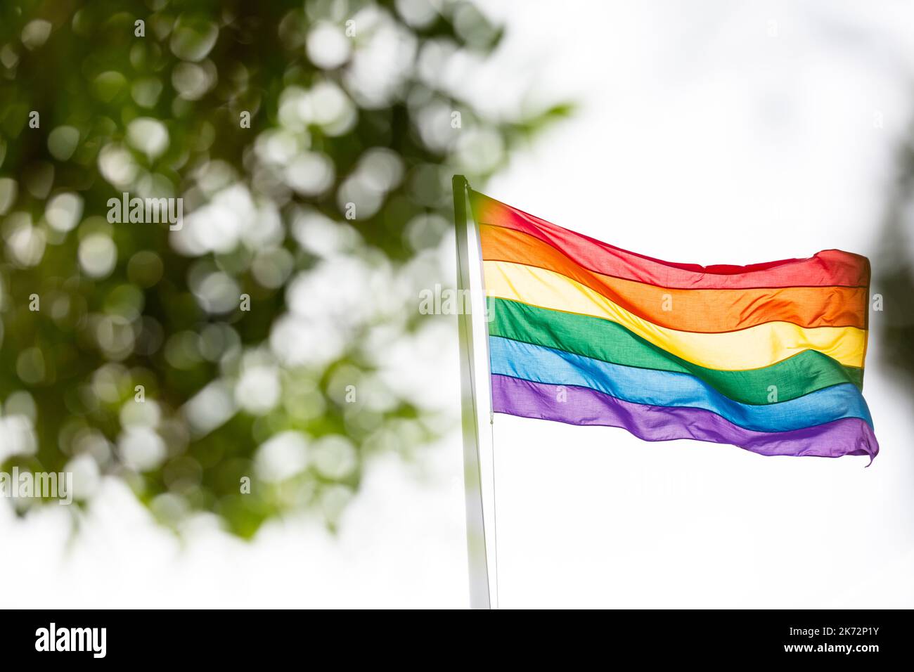 Rainbow flag in wind Stock Photo - Alamy