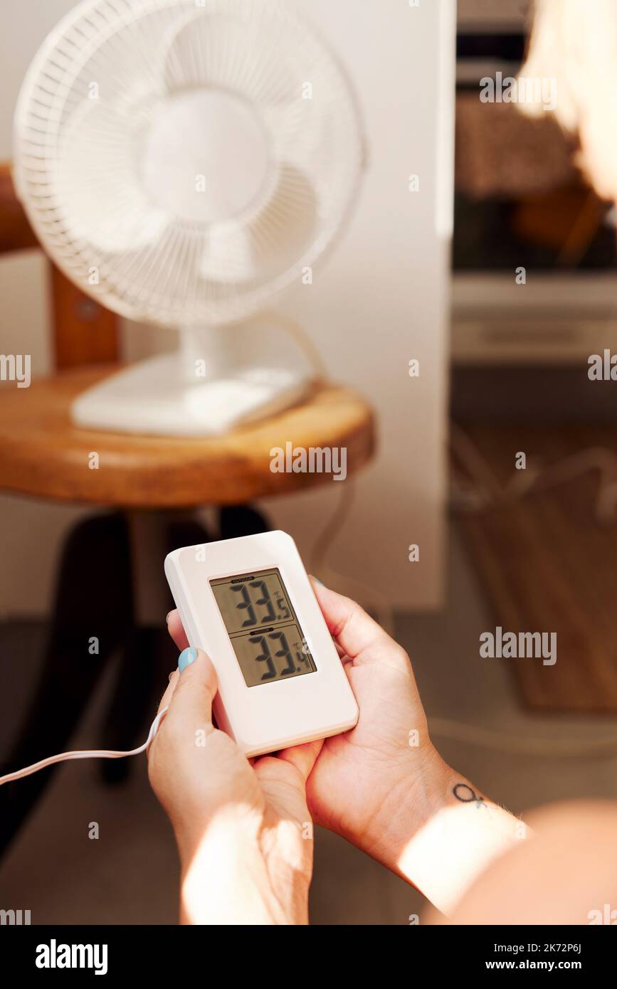 Woman holding thermostat at home Stock Photo - Alamy