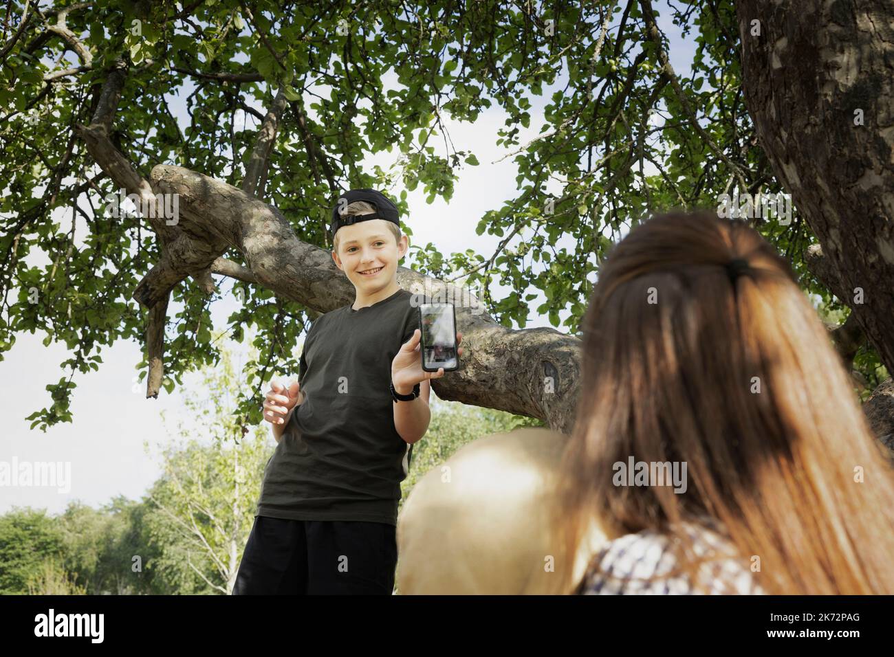 Smiling boy using cell phone Stock Photo - Alamy Smiling boy using cell phone Stock Photo - Alamy