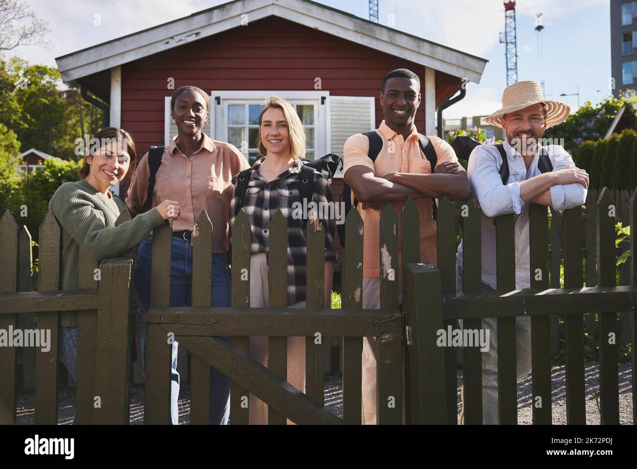 Smiling friends standing together Stock Photo - Alamy