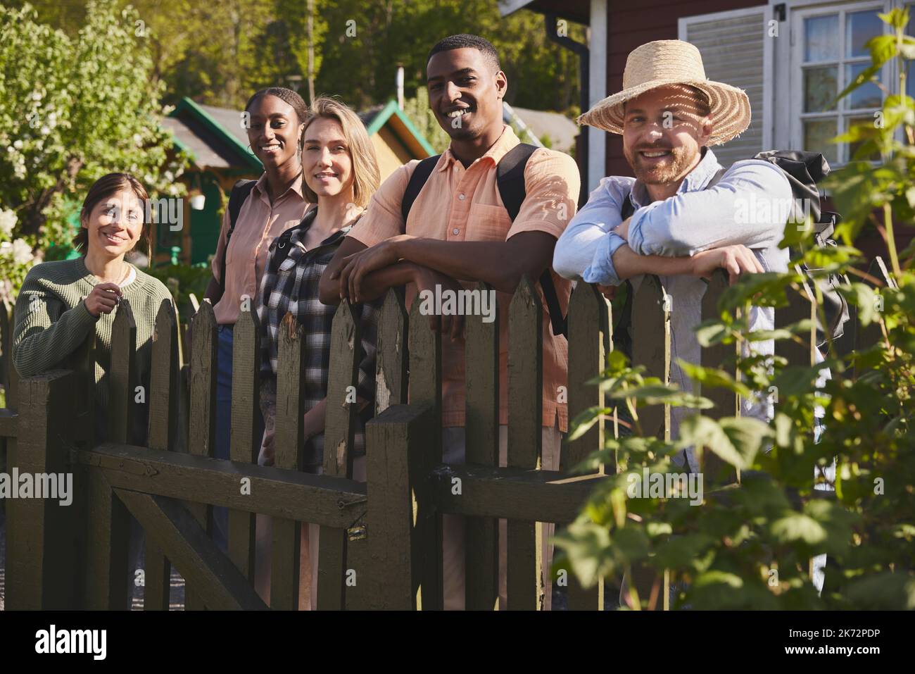 Smiling friends standing together Stock Photo - Alamy