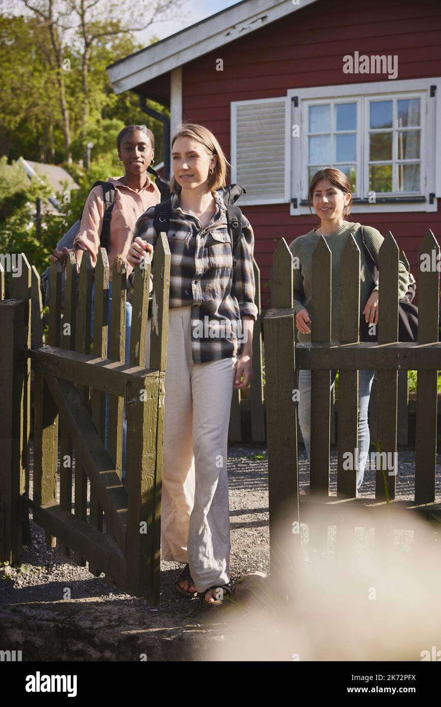 Female friends at wooden fence Stock Photo - Alamy