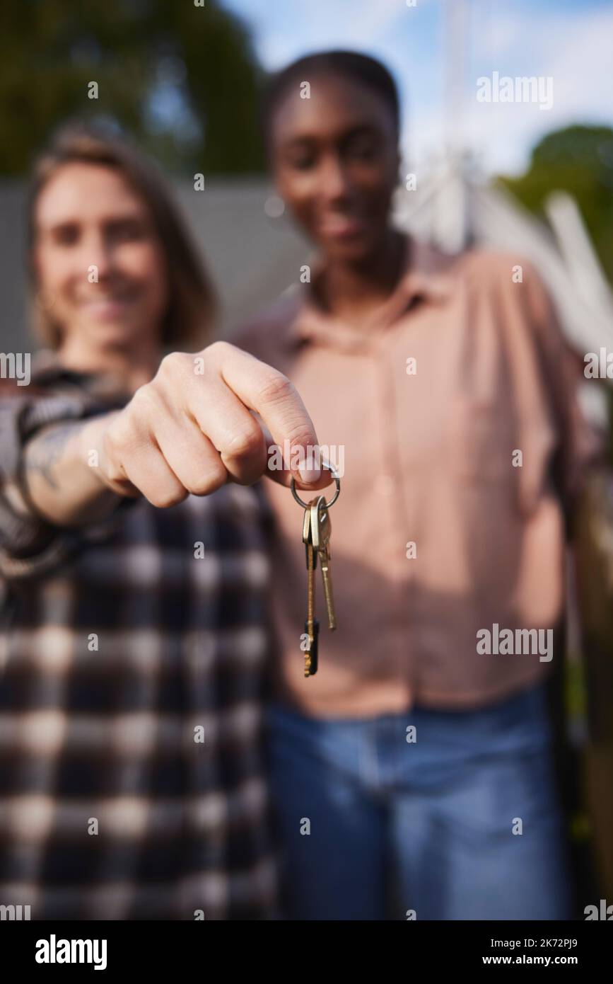 Smiling women holding house keys Stock Photo - Alamy