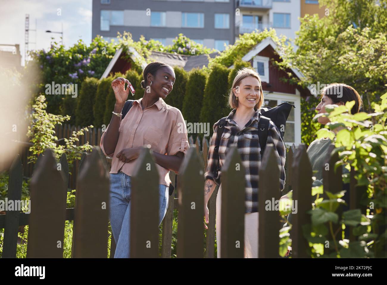 Smiling friends talking together Stock Photo - Alamy