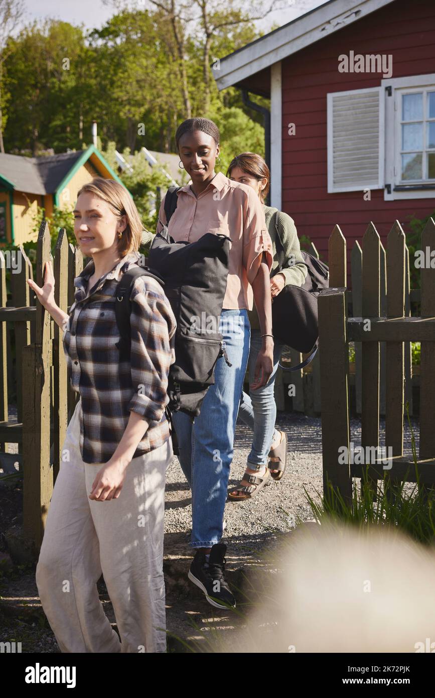 Female friends at wooden fence Stock Photo - Alamy