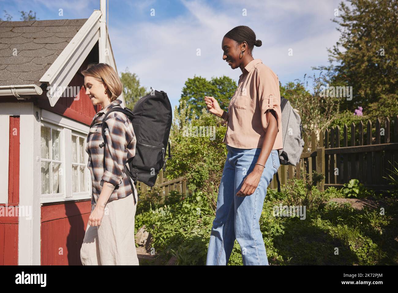 Smiling friends walking together Stock Photo - Alamy