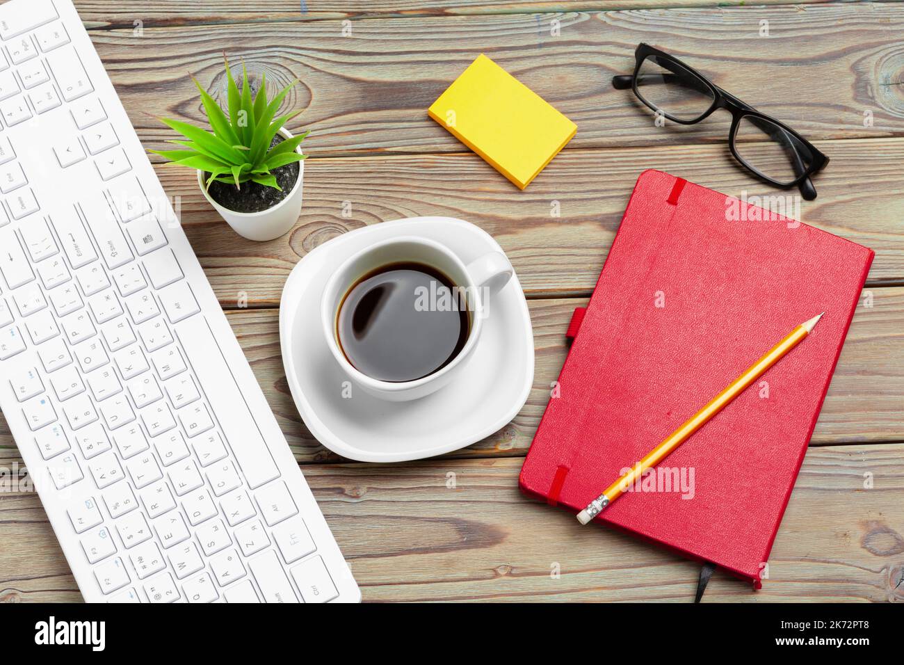 Top view of wooden desktop with glasses and stationery items close up ...
