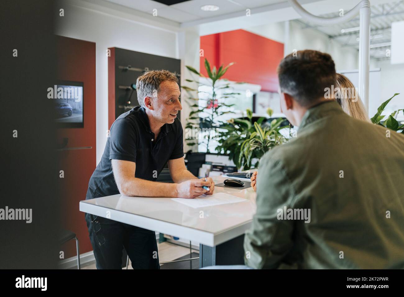 Mature customer young salesman hi-res stock photography and images - Alamy