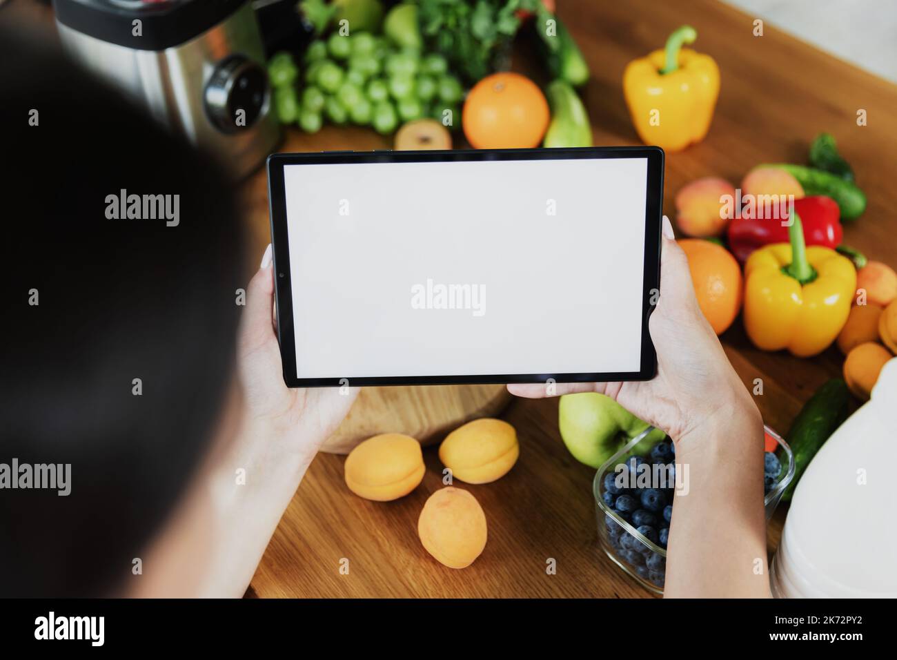 Female hands holding tablet with empty blank white screen mockup in ...