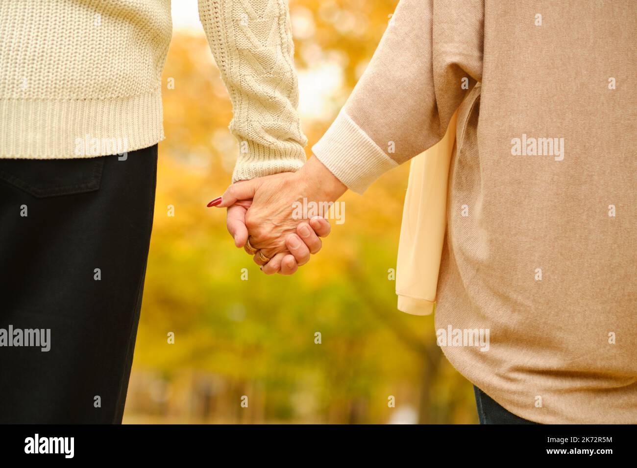 Smart couple holding hands hi-res stock photography and images - Alamy