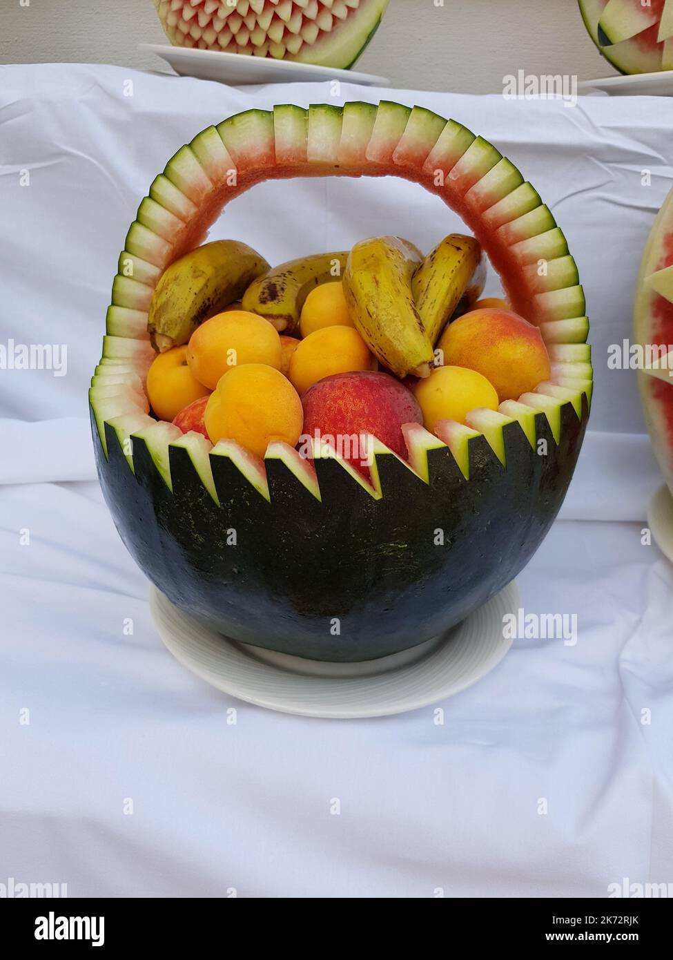 Large fresh watermelon with carved decorations on the counter ...