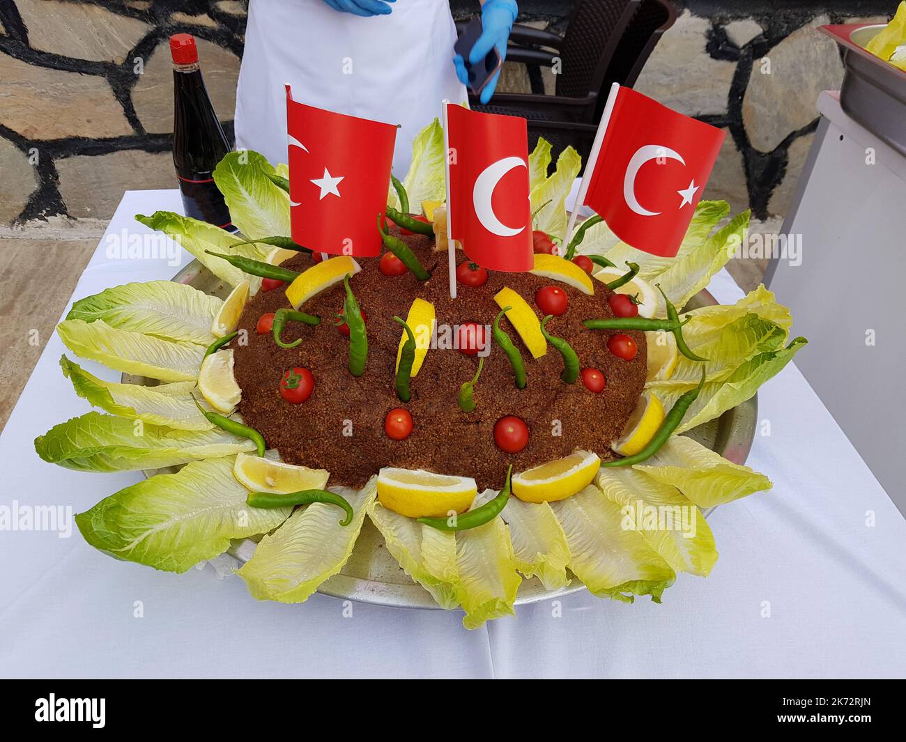 Turkish national food Cig kofte garnished with lettuce, lemon, tomato ...