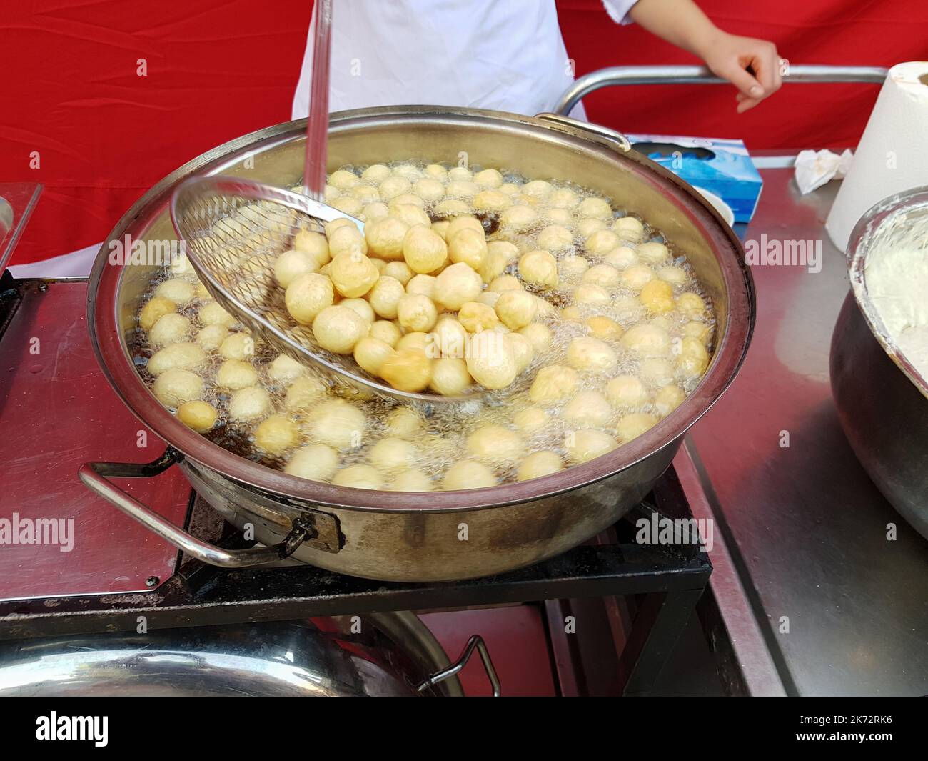 Cooking fry curd balls in boiling hot oil. Turkish donuts Lokma Stock ...