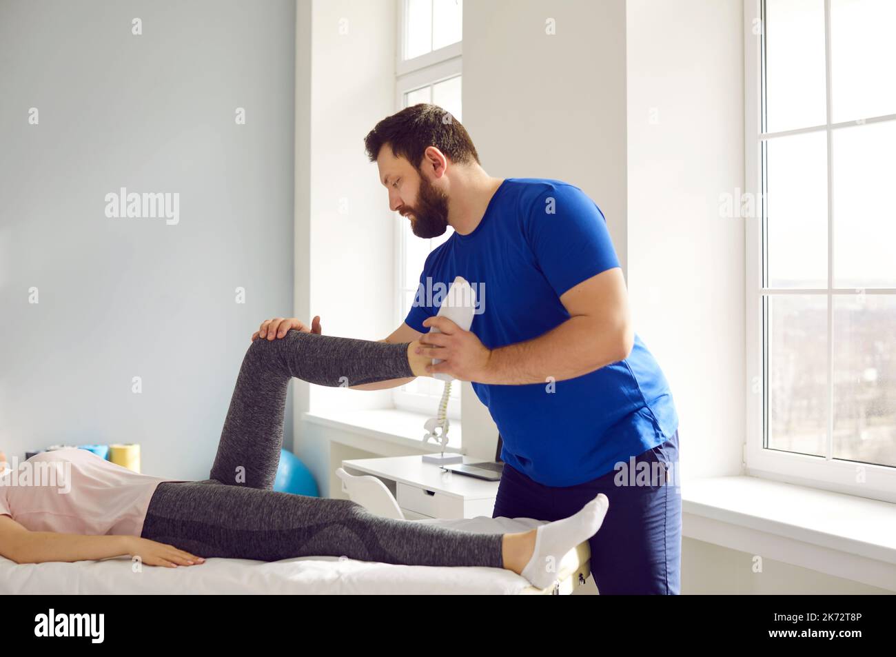 Male physiotherapist work female patient legs Stock Photo - Alamy