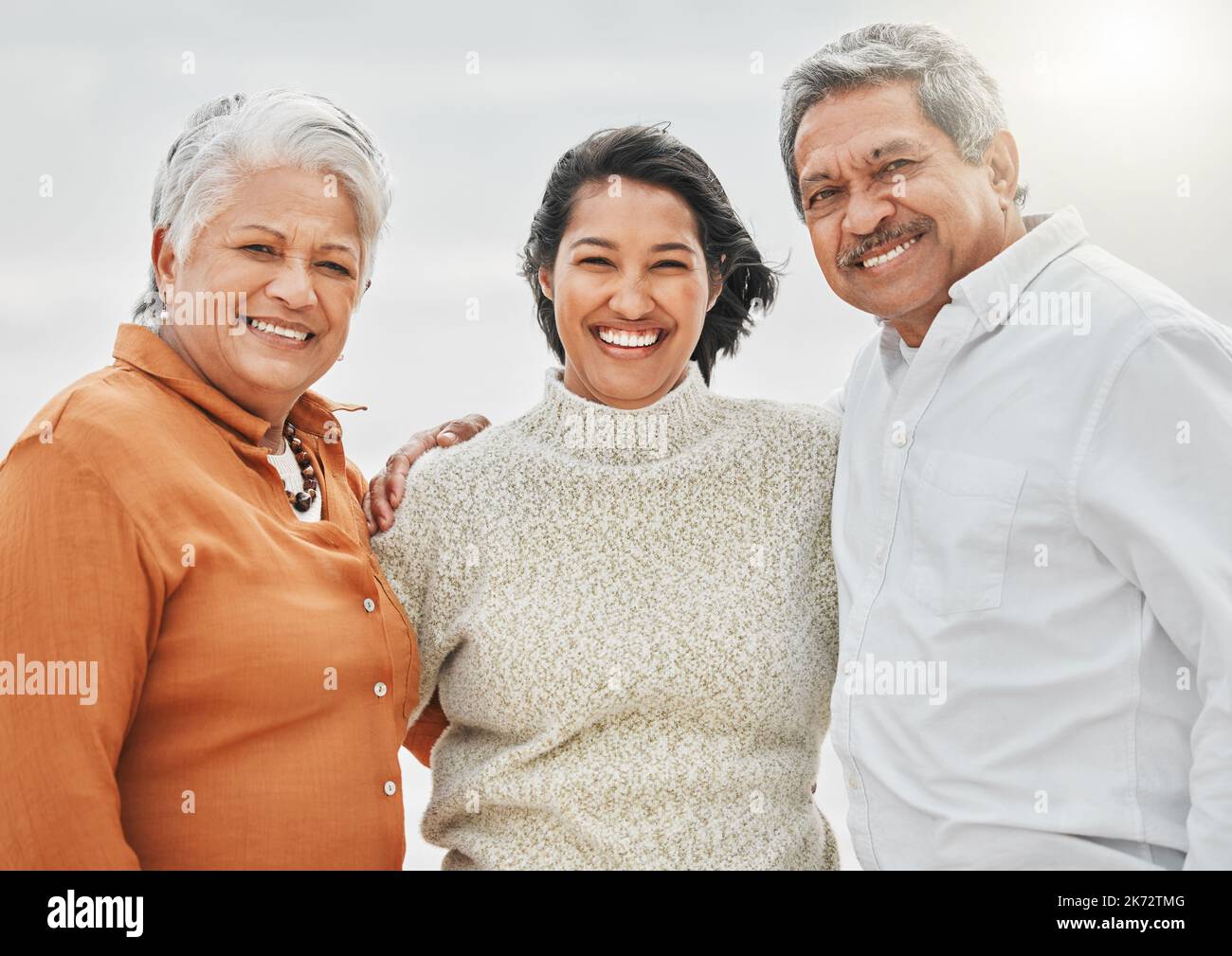 My parents love the beach. an attractive young woman and her parents on ...
