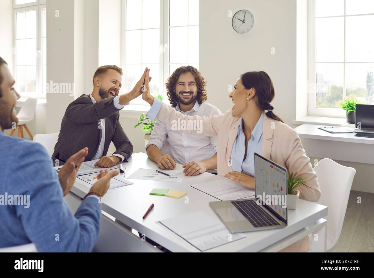 Overjoyed diverse employees give high five celebrate business success ... Overjoyed diverse employees give high five celebrate business success ...
