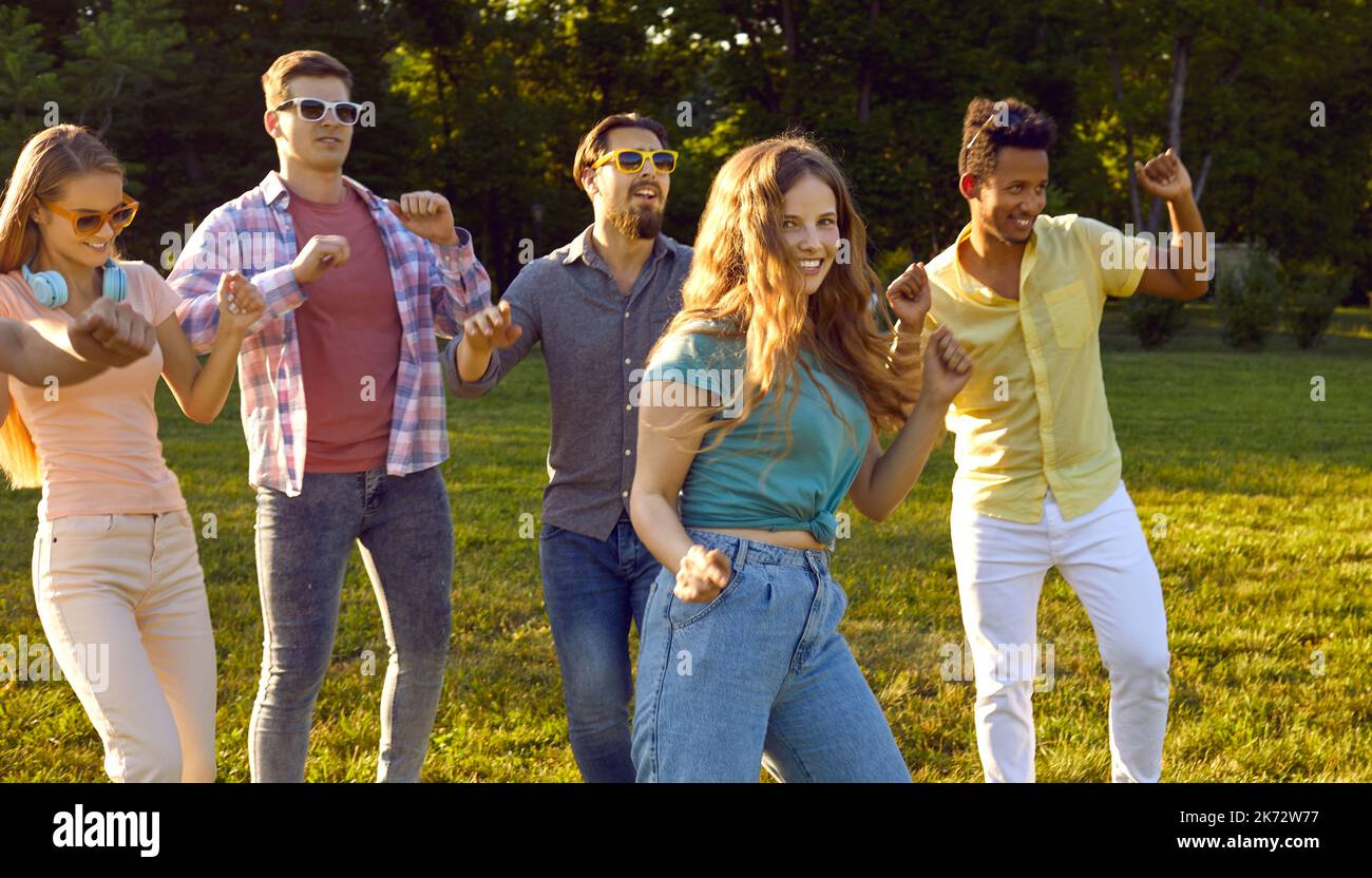Various cheerful excited friends are dancing, having fun and enjoying ...