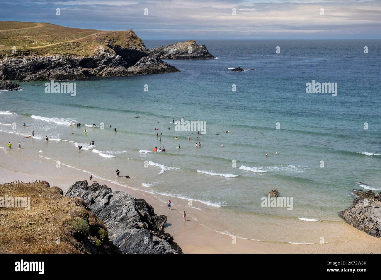Holidaymakers in the sea at the secluded Polly Porth Joke on the coast ...