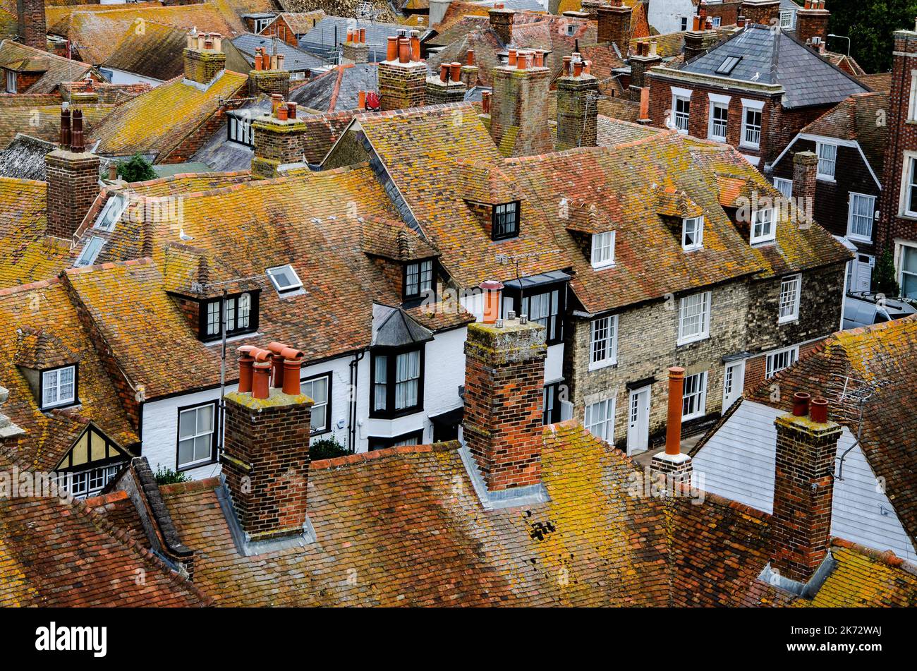 Roofs of village in England with red tiles and moss from above as ...