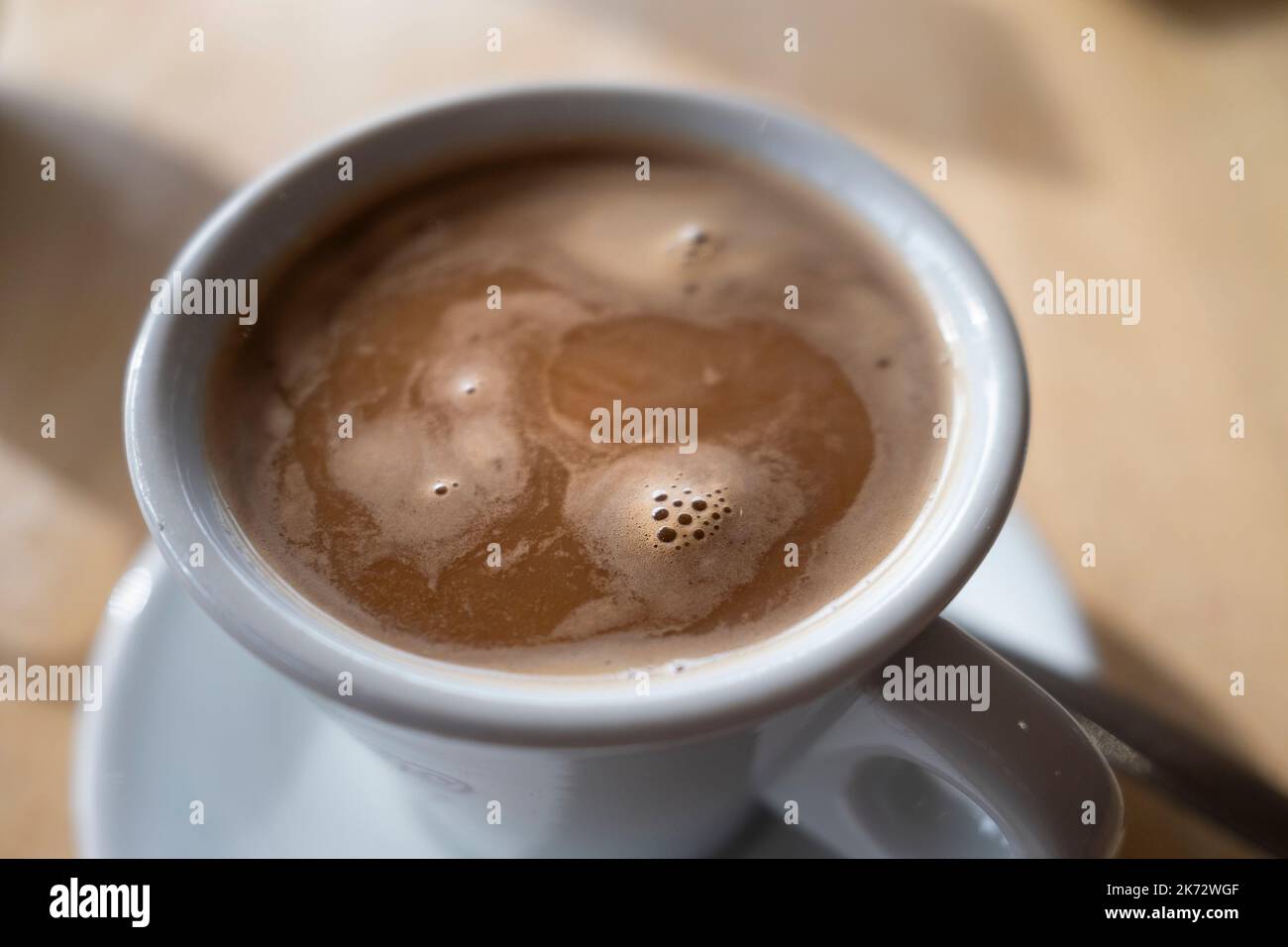 A closeup close up of the bubbles and froth floating on the surface of ...