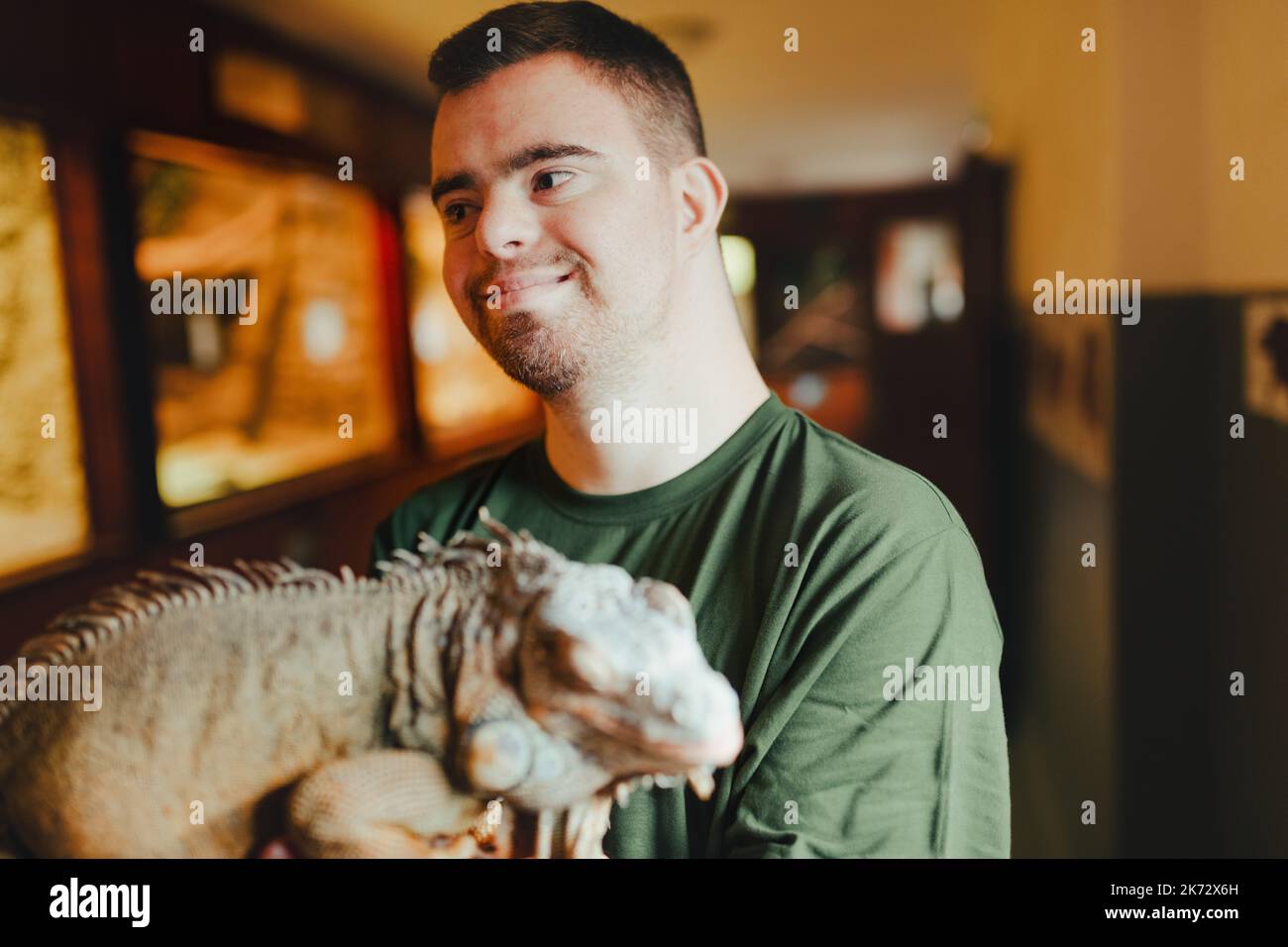 Portrait of caretaker with down syndrome taking care of animals in zoo ...