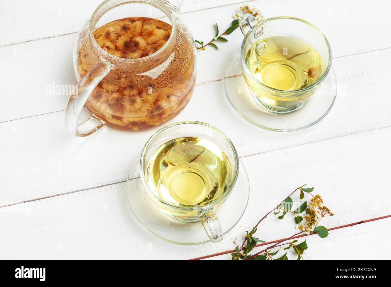 Glass kettle and cup of herbal tea on white wooden background Stock ...