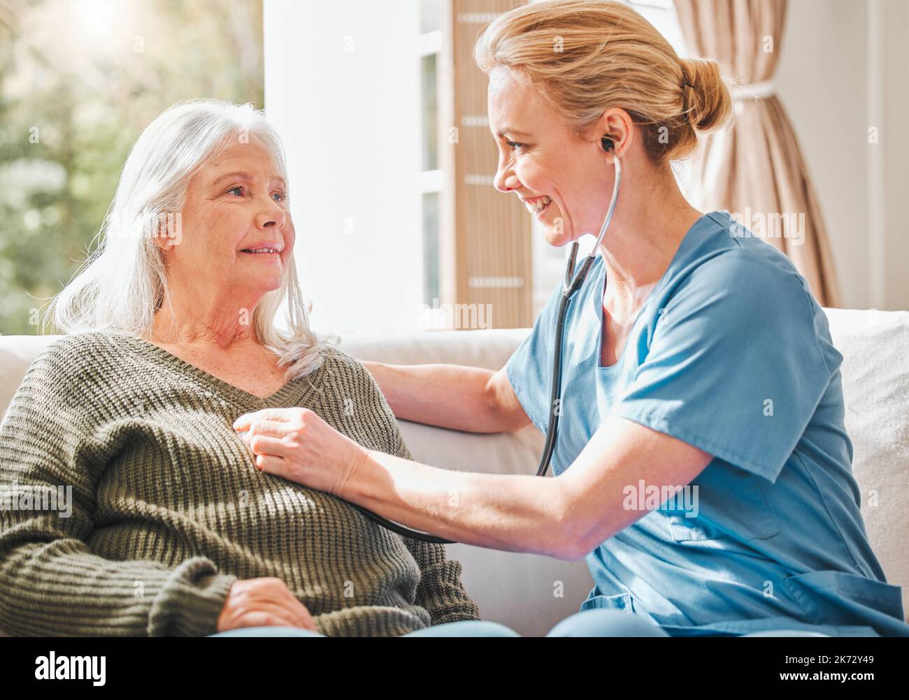 Your chest sounds clear to me. a female nurse listening to her patients ...