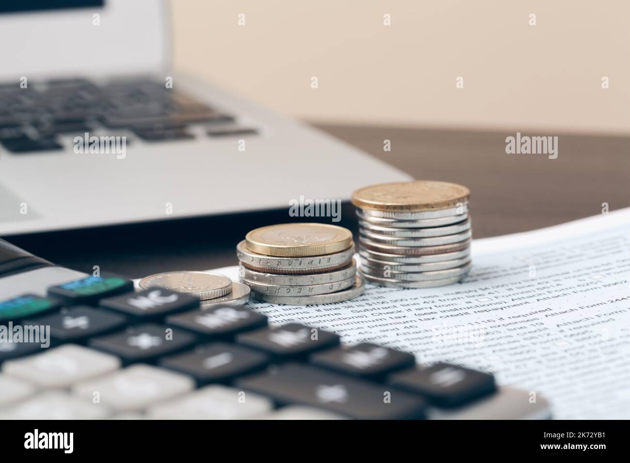 pile of money coins with graph paper on wood table, concept in account ...
