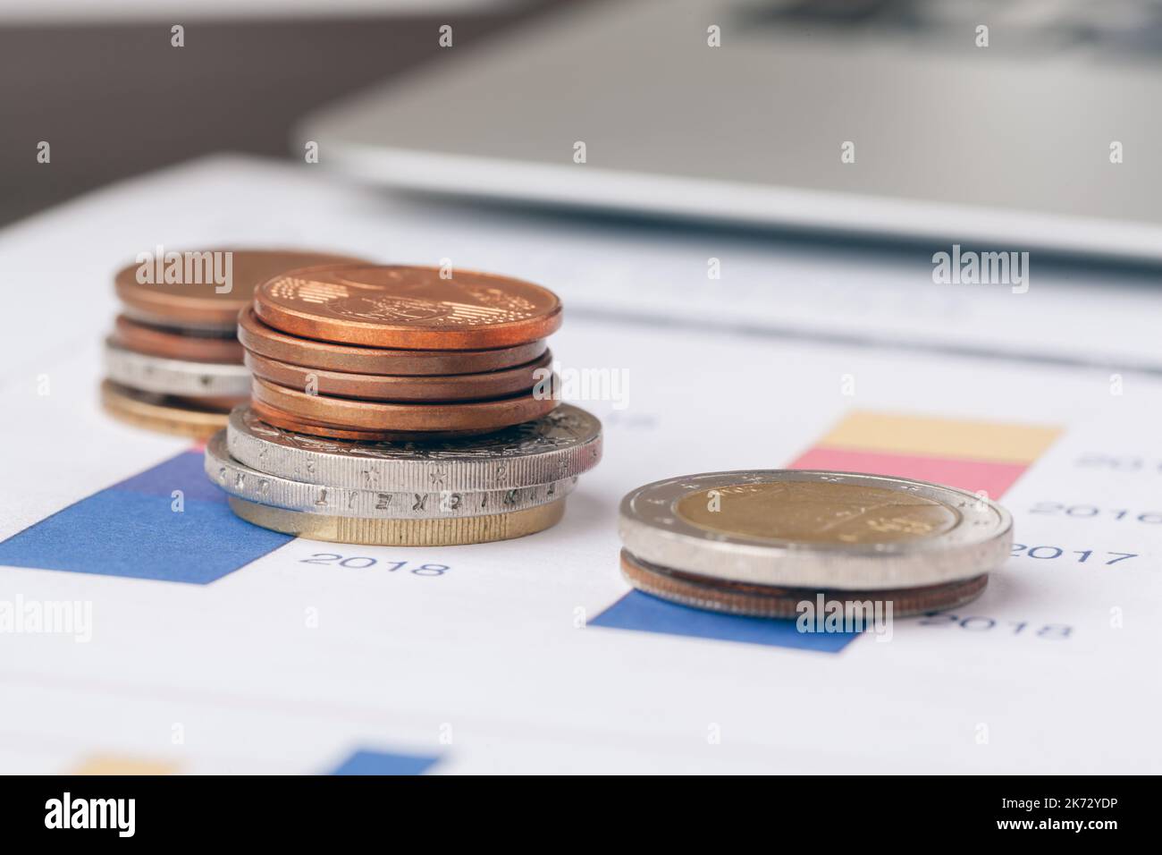pile of money coins with graph paper on wood table, concept in account ...