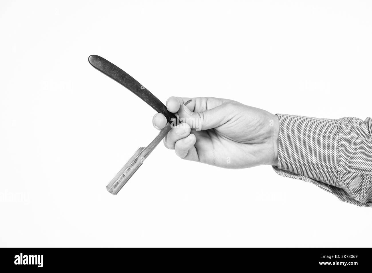 retro razor blade in hand of man isolated on white. hairdresser concept ...