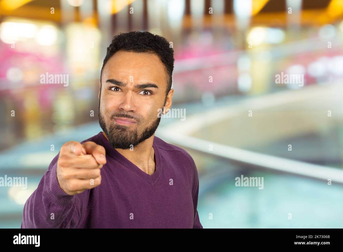 Photo of emotional angry young african man standing isolated Stock ...