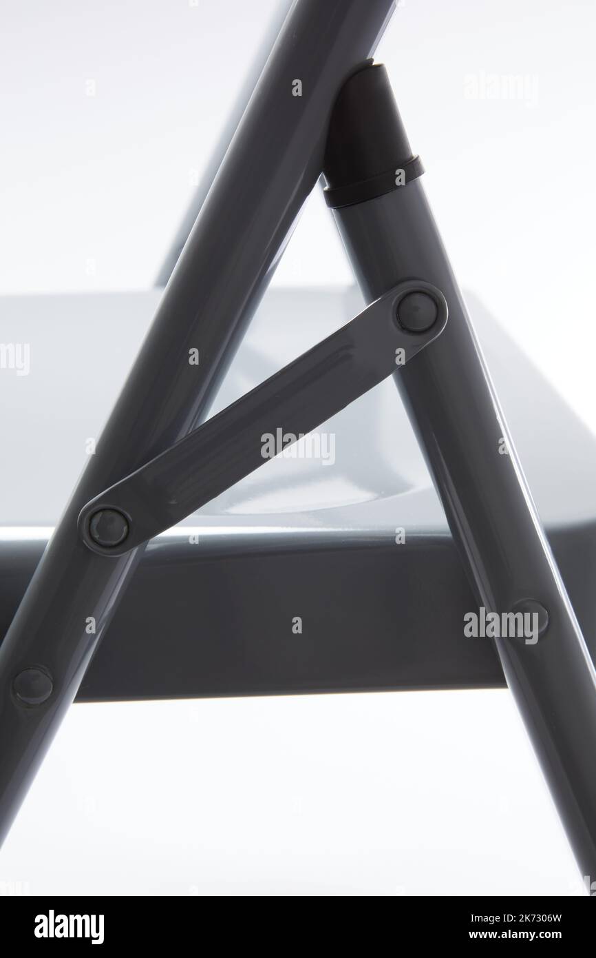 Close up detail of an Ikea grey metal chair, showing letter A shape ...