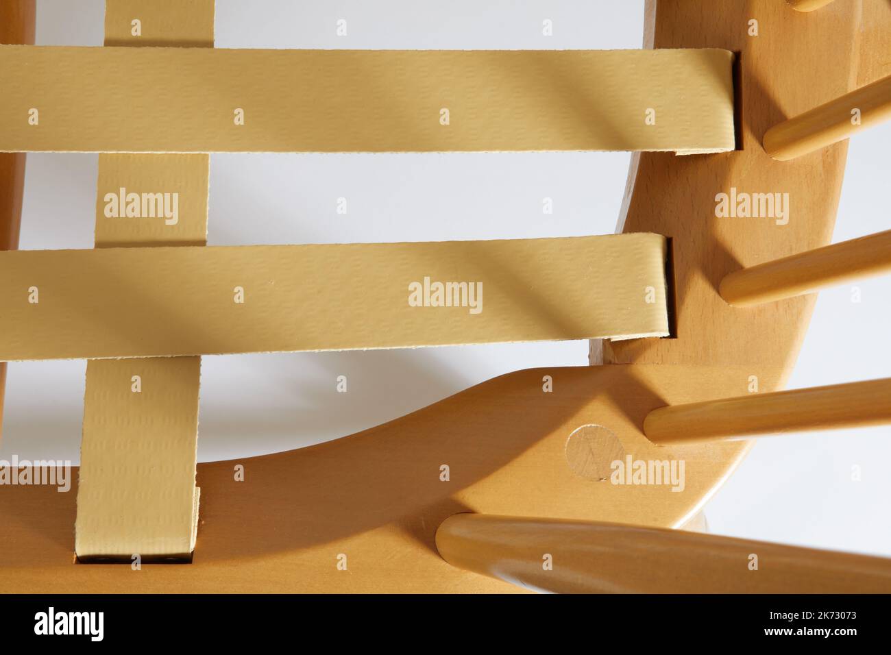 A close up detail of an Ercol 203 chair, showing abstract letter shape ...