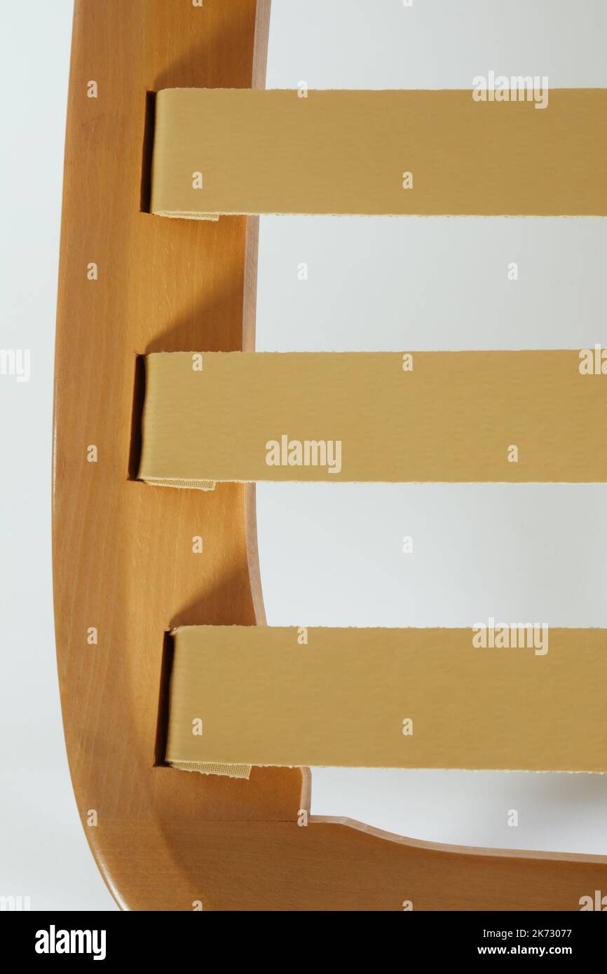 A close up detail of an Ercol 203 chair, showing abstract letter shape ...