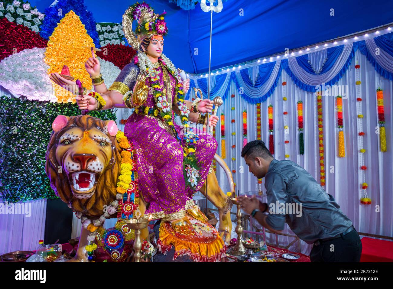 A person before an idol of Maa Durga at a mandal in Mumbai for the ...