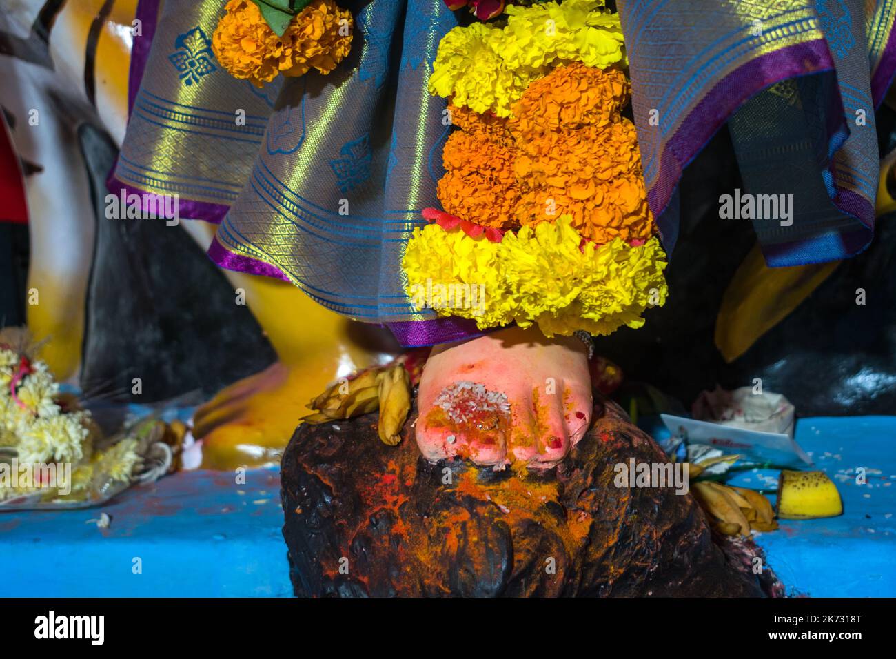 Close-up of feet of a beautiful idol of Maa Durga being worshipped at a ...