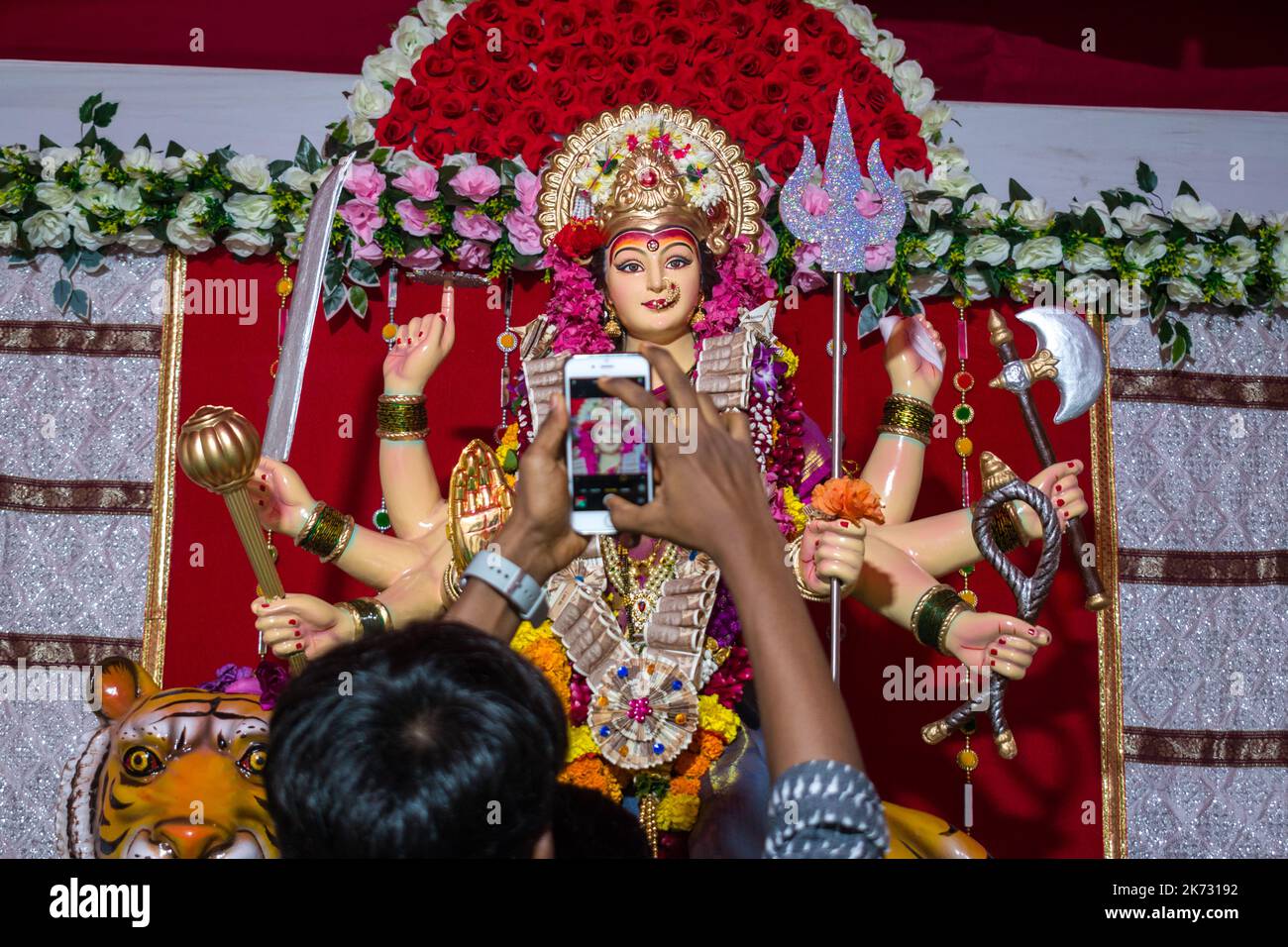 A man clicking a picture of an idol of Maa Durga at a mandal in Mumbai ...