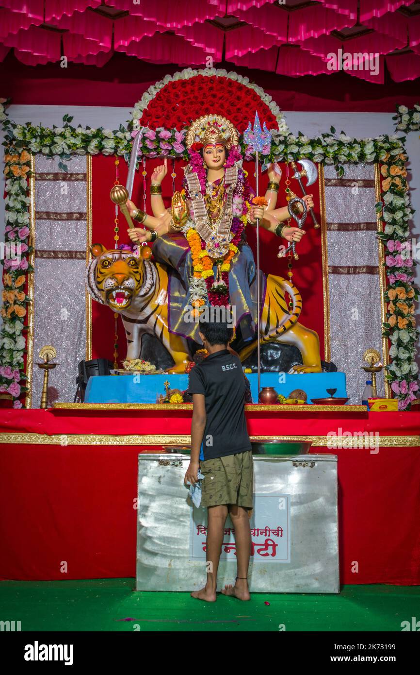A person before an idol of Maa Durga at a mandal in Mumbai for the ...