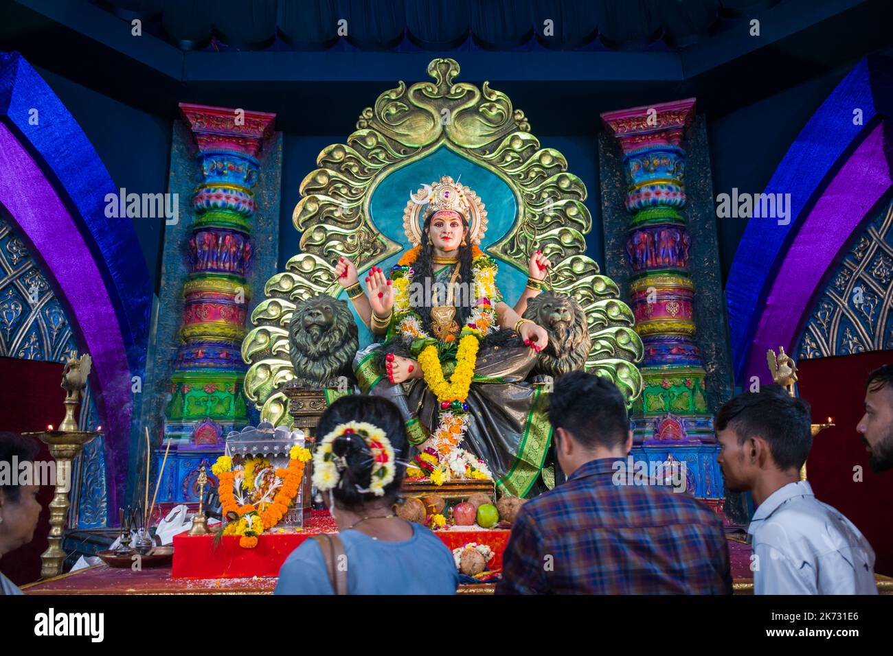 A person before an idol of Maa Durga at a mandal in Mumbai for the ...