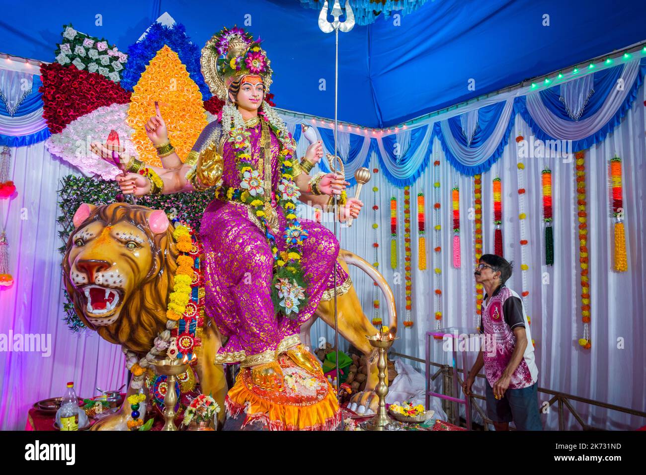A person before an idol of Maa Durga at a mandal in Mumbai for the ...