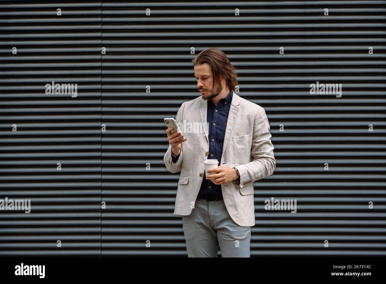 Focused man texting sms using app on smartphone during his break in the ...
