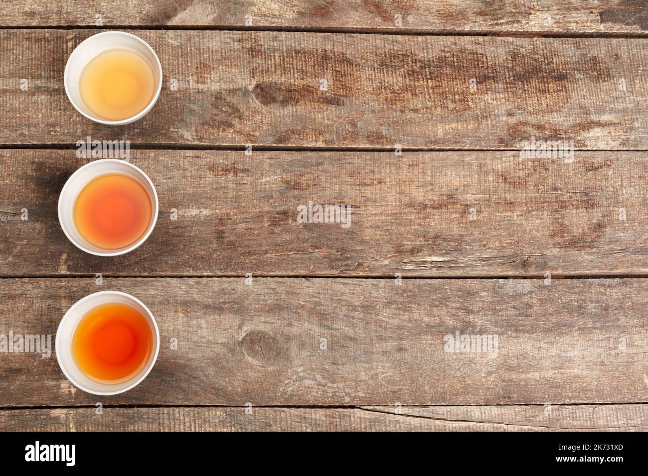 Collection of different teas in cups with tea leaves Stock Photo - Alamy