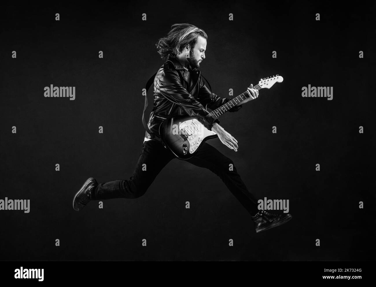 musician guitar player jumping. playing rock music. stylish crazy man ...