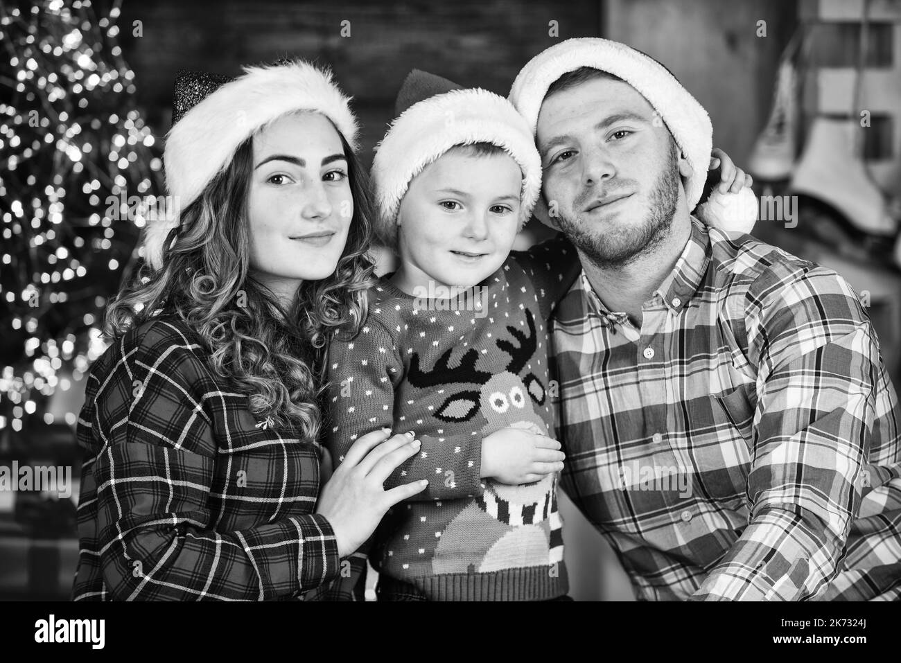 Happy holidays. Christmas tradition. Father and mother with cute son ...