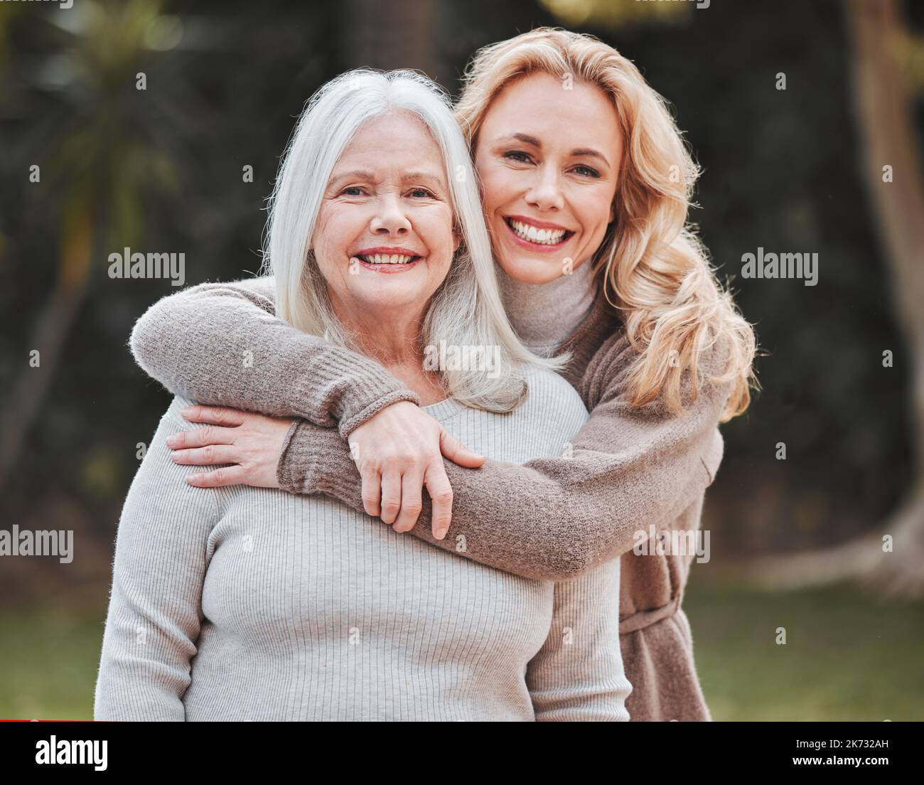 She must get her good looks from her mom. a woman standing outside with ...